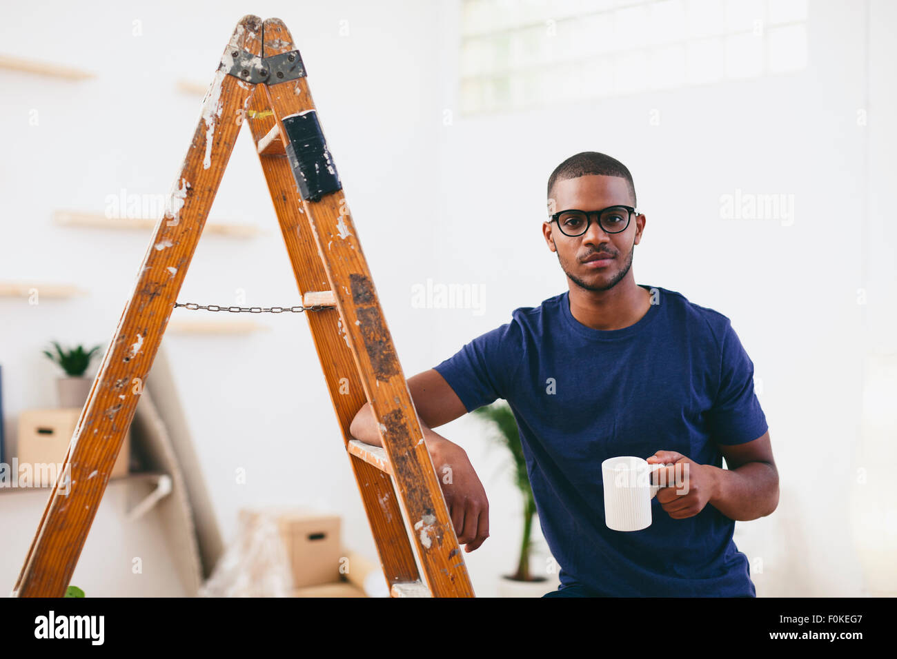 Person standing on a step ladder hi-res stock photography and images ...