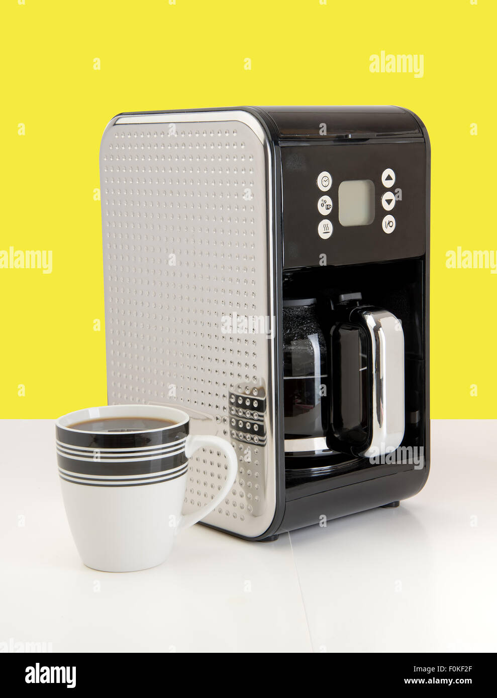 Fresh Coffee pouring into fancy cup on table top Stock Photo - Alamy