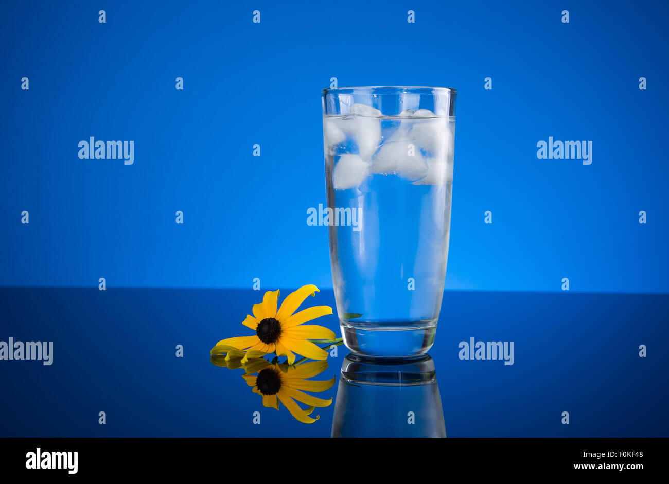 Pouring cold water into an iced glass Stock Photo - Alamy