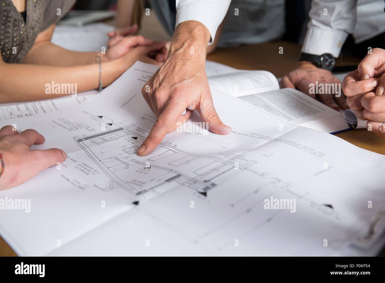 Hand pointing on construction plan hi-res stock photography and images ...