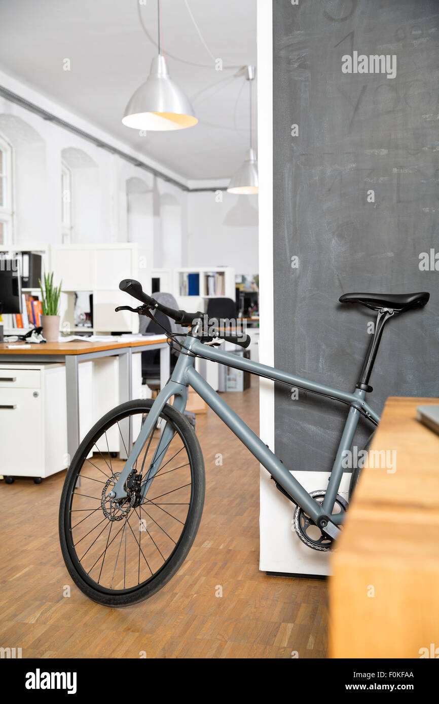 Bicycle in office Stock Photo - Alamy