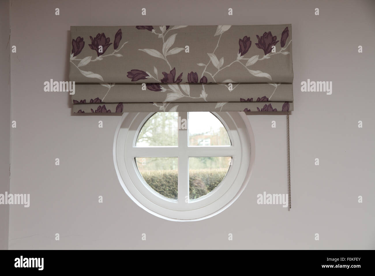 Round window with roman blind Stock Photo - Alamy