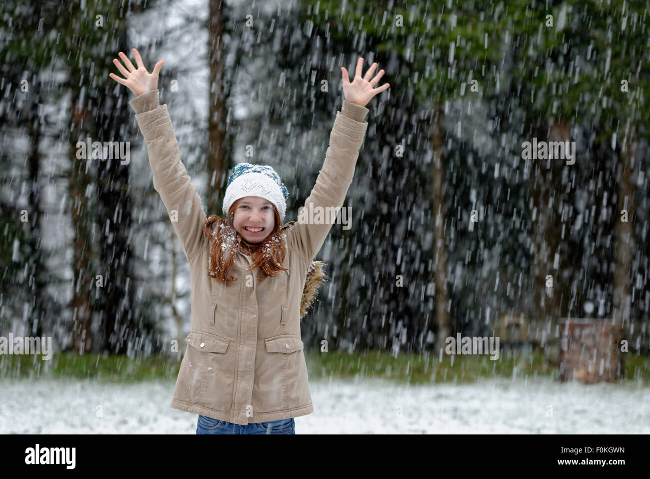 Girl enjoying snow fall, beginning of winter Stock Photo - Alamy