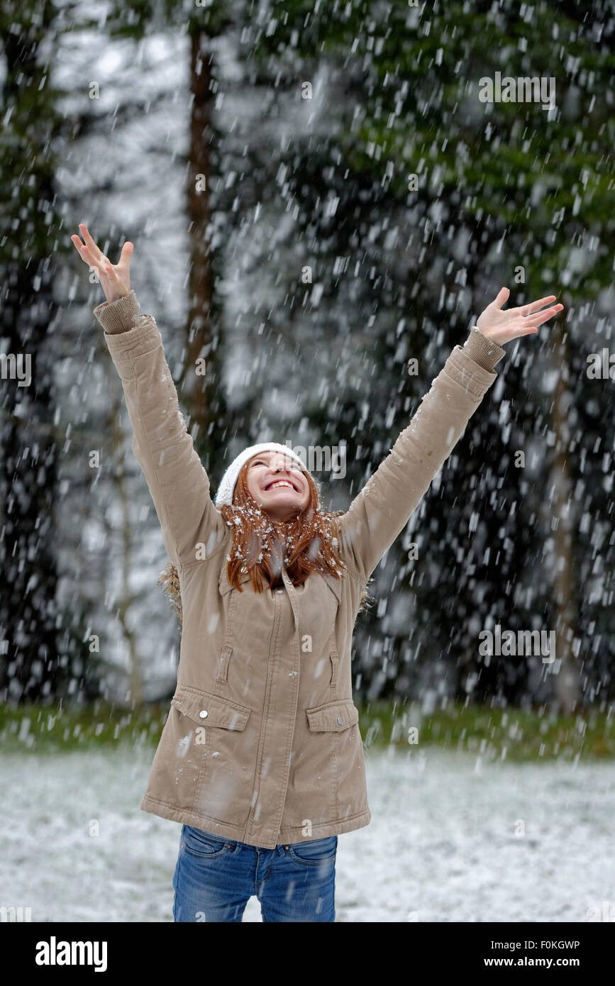 Girl enjoying snow fall, beginning of winter Stock Photo - Alamy
