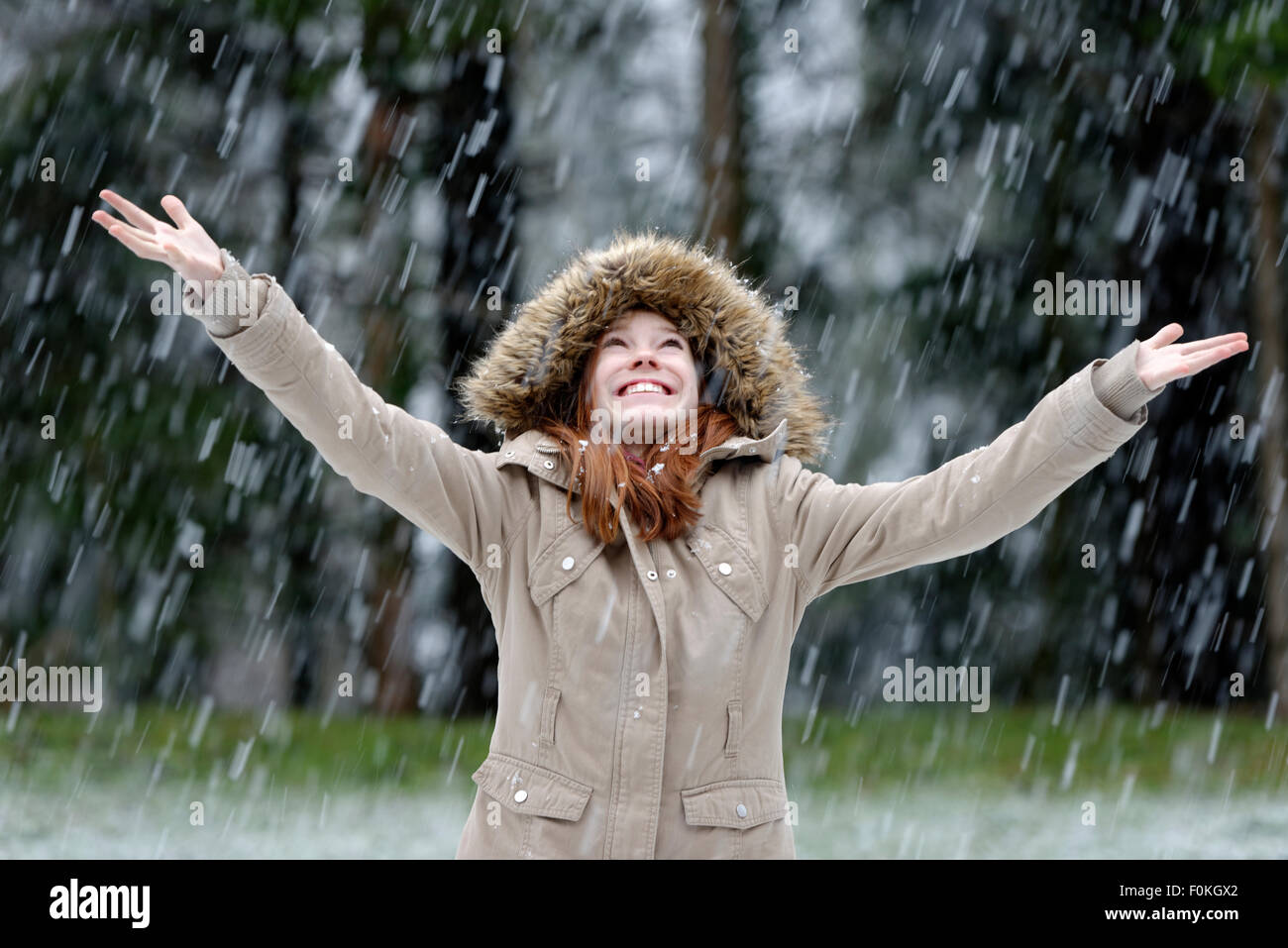 Girl enjoying snow fall, beginning of winter Stock Photo - Alamy