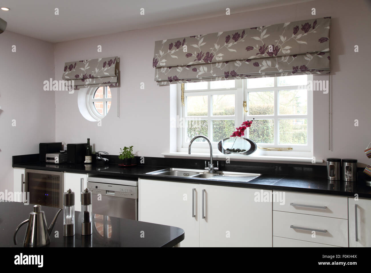 White kitchen with black work counter Stock Photo - Alamy