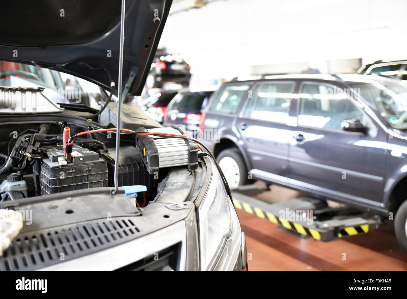 Car with open bonnet in garage Stock Photo - Alamy