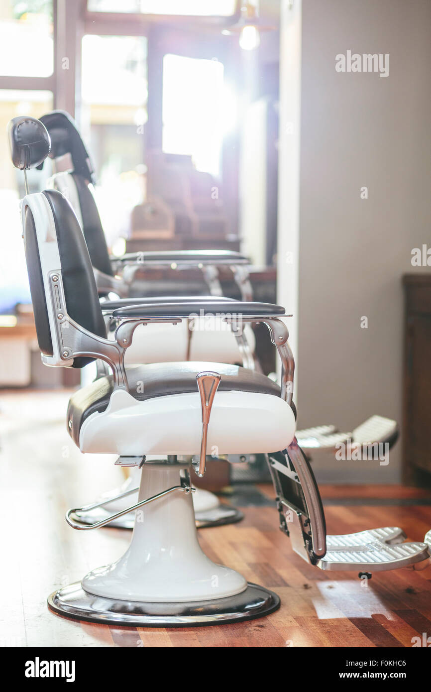 Hairdresser chairs in a barber shop Stock Photo - Alamy