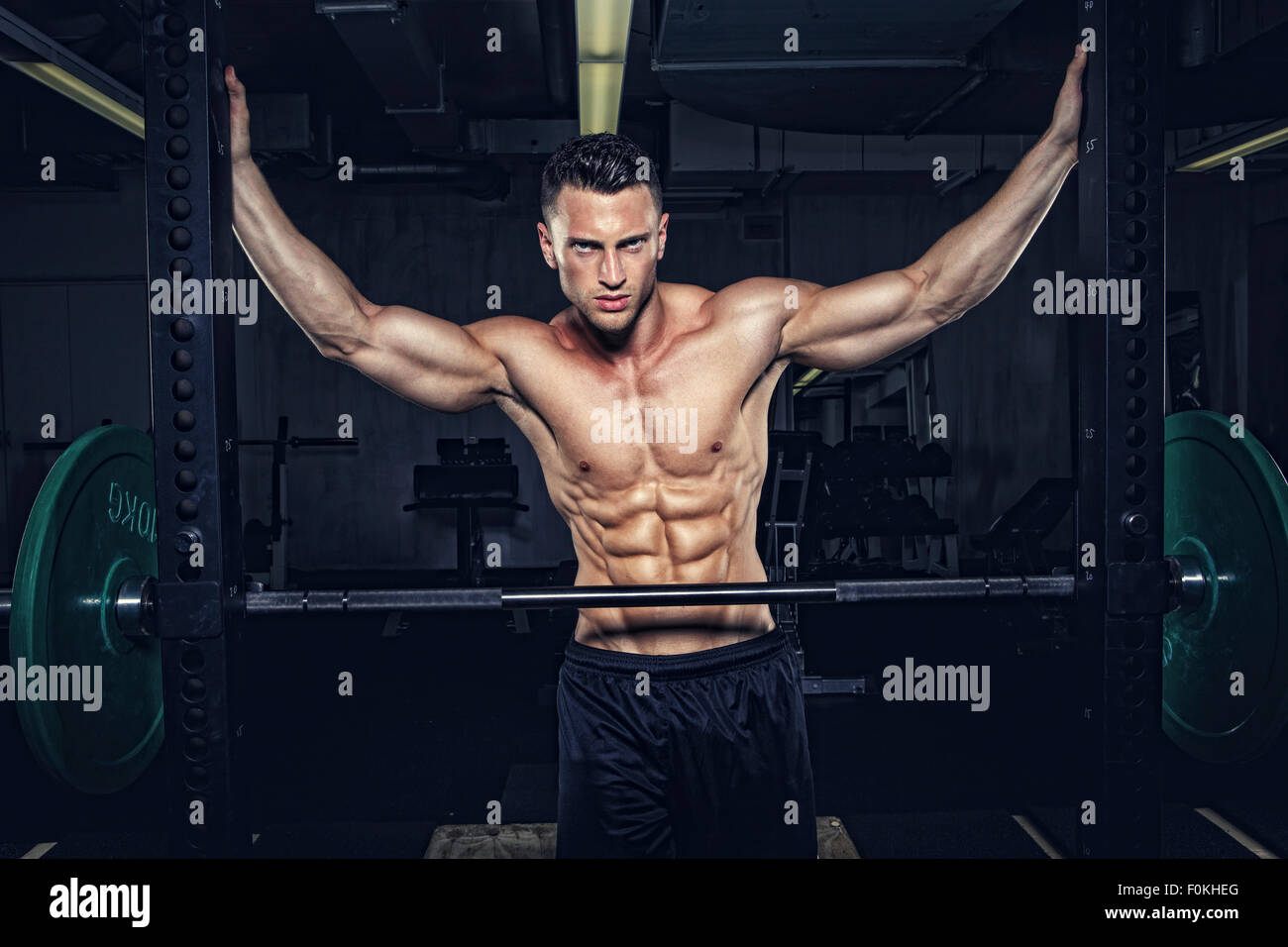 Physical athlete at Power Rack in gym Stock Photo - Alamy