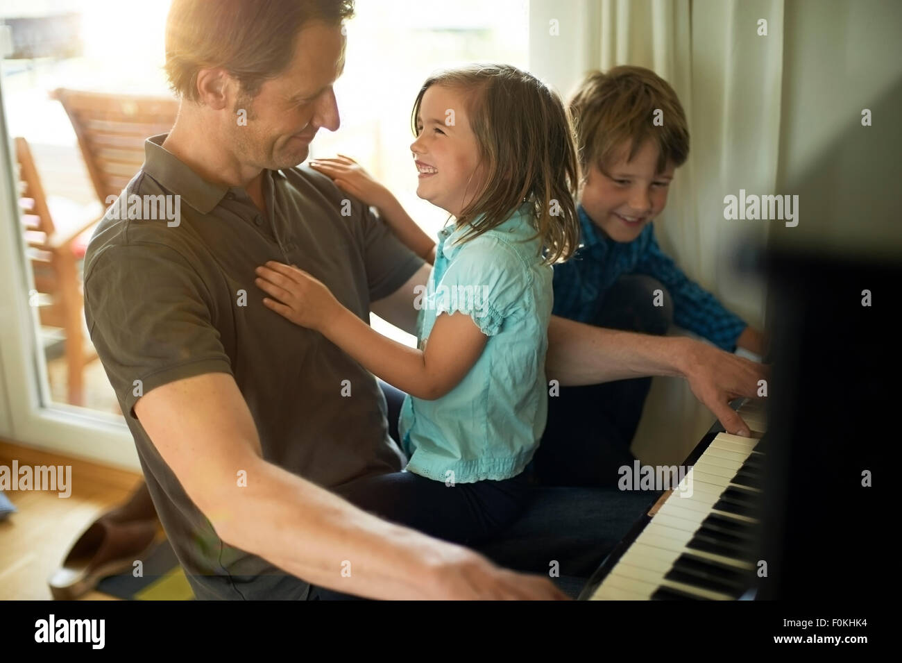 Father and son sitting at piano hi-res stock photography and images - Alamy