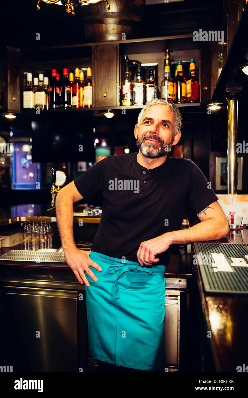 Portrait of smiling waiter in an Irish pub Stock Photo - Alamy