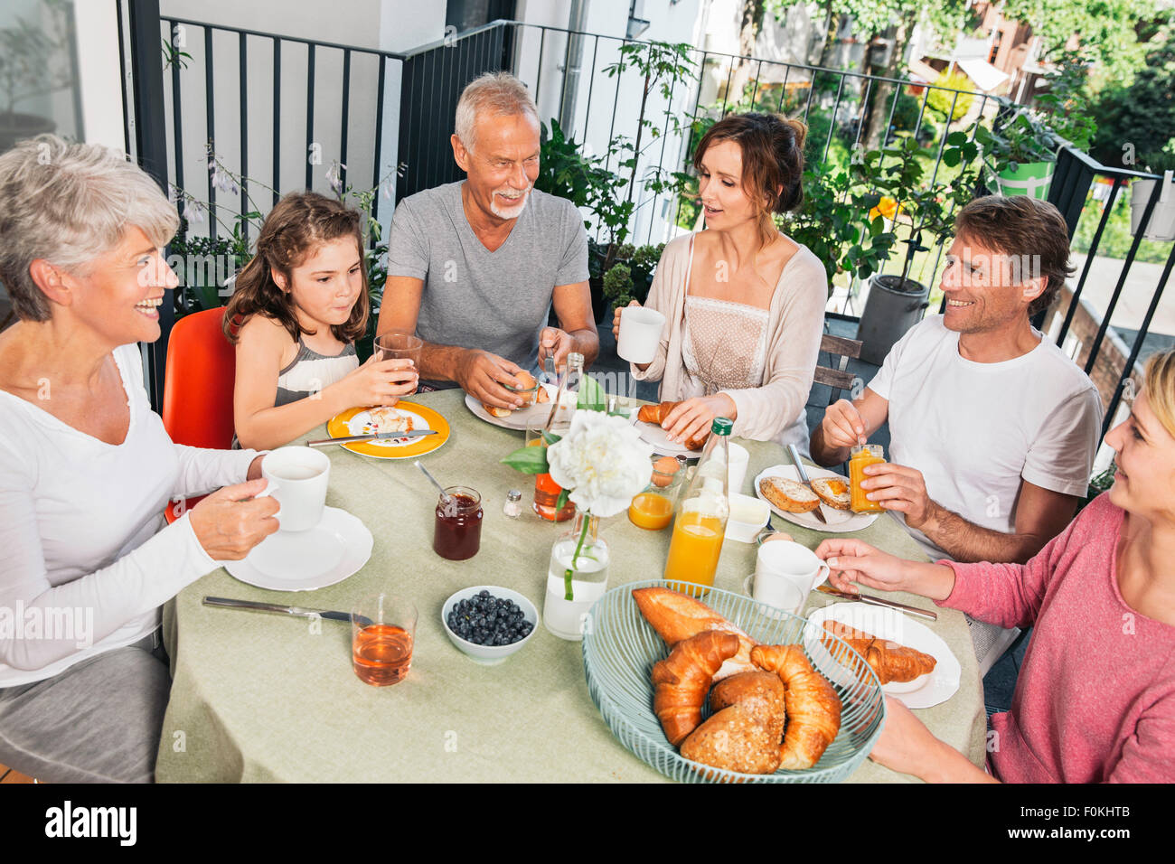 Family having breakfast on balcony Stock Photo - Alamy