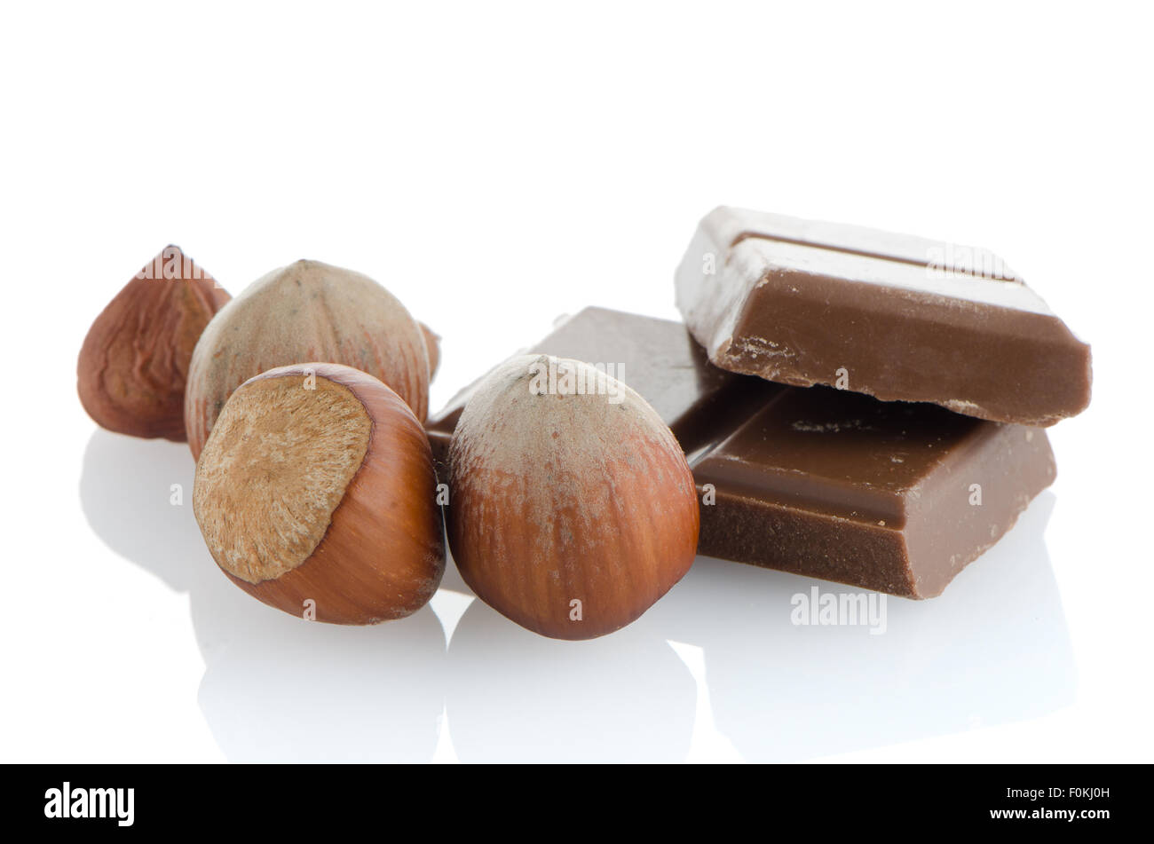 Chocolate parts and hazelnuts isolated on white background Stock Photo ...