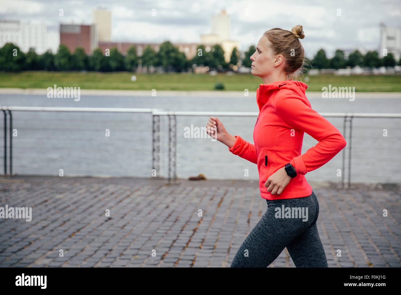 Germany, Cologne, young woman jogging at River Rhine Stock Photo - Alamy