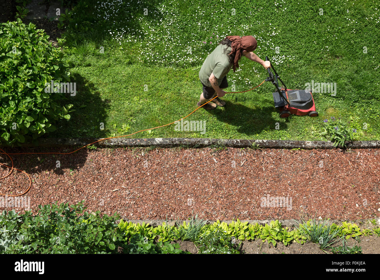 Man mowing the lawn Stock Photo - Alamy