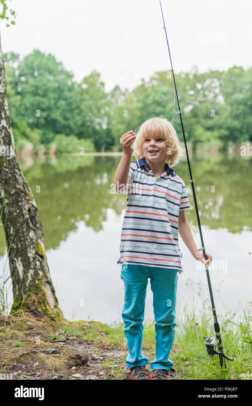 Germany, Boy preparing fishing rod Stock Photo - Alamy