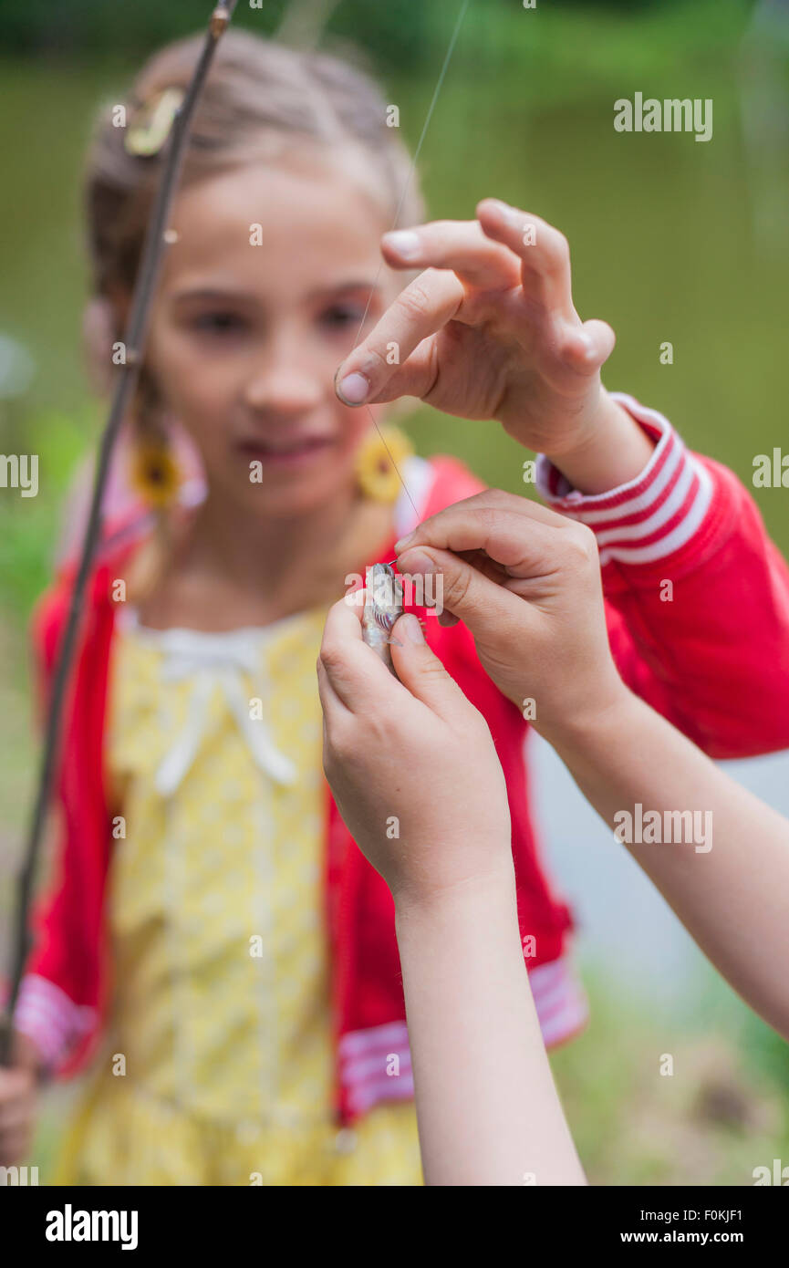Germany, Girl with rod and small fish Stock Photo - Alamy