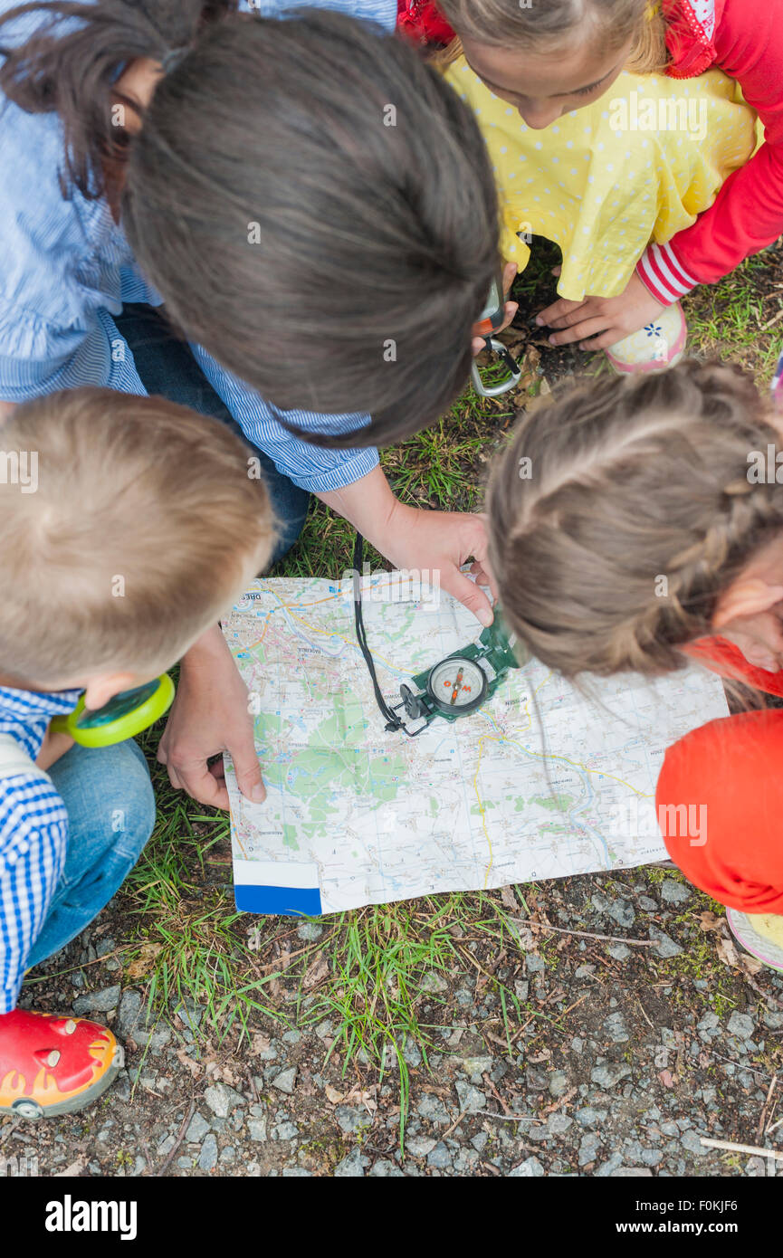 Germany, Children learning how to use compass and map Stock Photo - Alamy