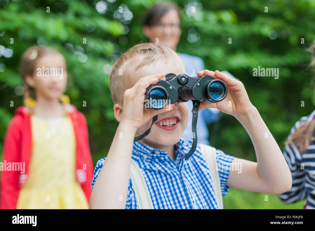 Germany, Boy with binoculars watching animals Stock Photo - Alamy