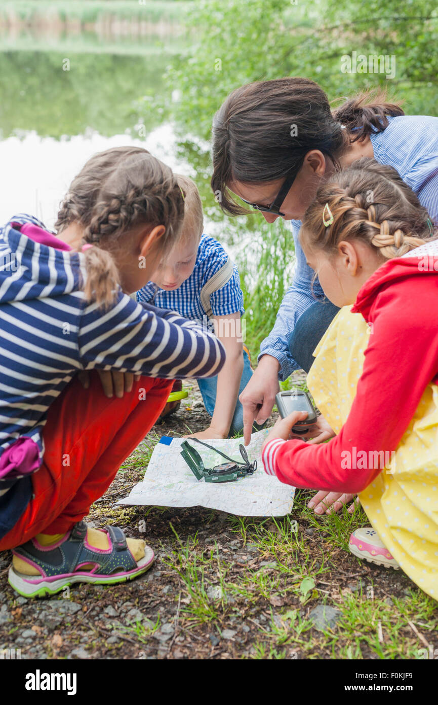 Germany, Children learning how to use compass and map Stock Photo - Alamy