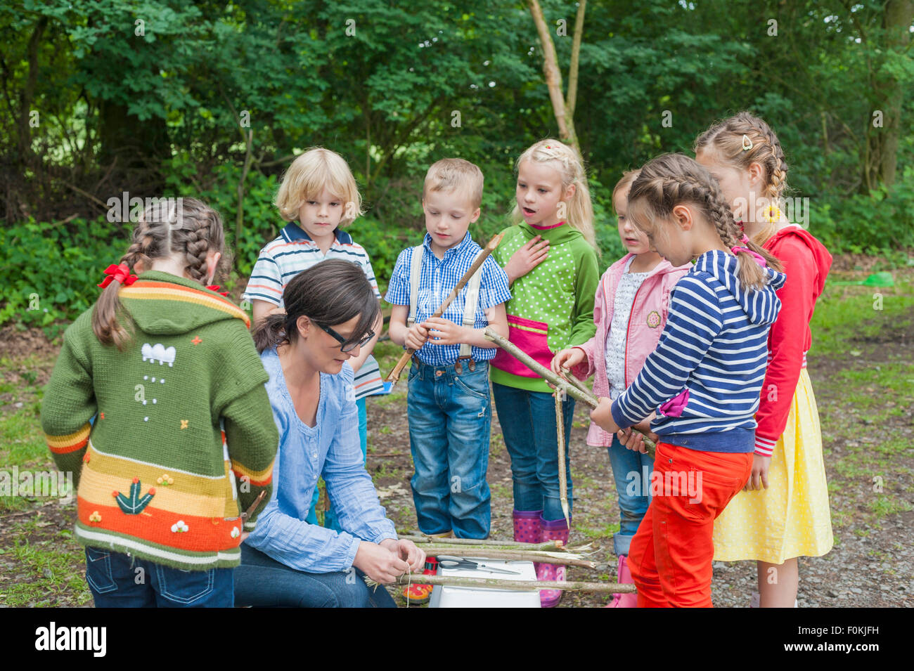Germany, Children learning how to build a wooden raft Stock Photo - Alamy