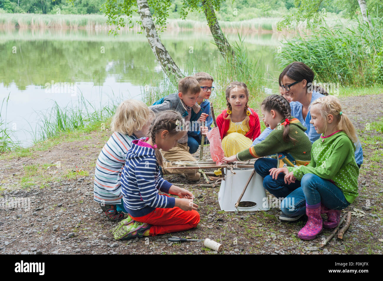 Germany, Children learning how to build a wooden raft Stock Photo - Alamy