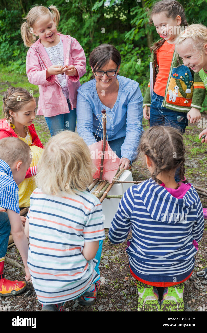 Germany, Children learning how to build a wooden raft Stock Photo - Alamy