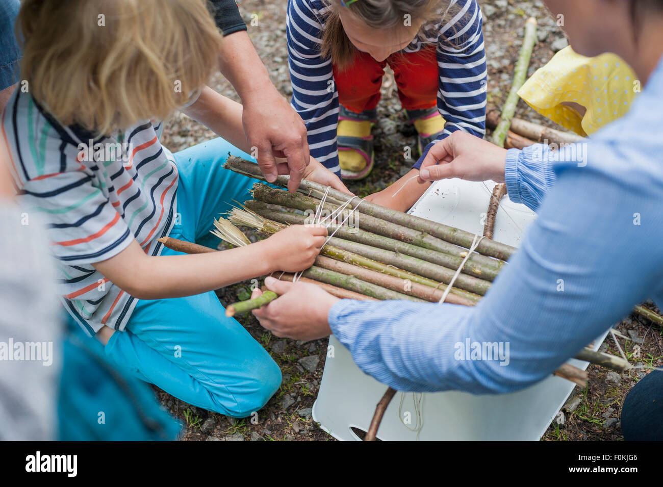 Germany, Children learning how to build a wooden raft Stock Photo - Alamy