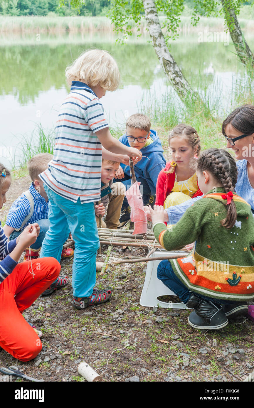 Germany, Children learning how to build a wooden raft Stock Photo - Alamy
