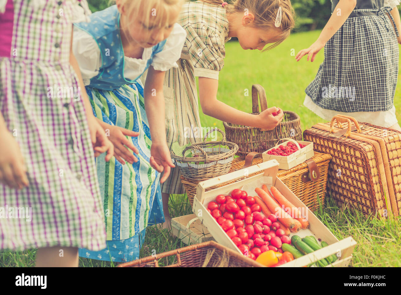 Germany, Saxony, little girls in traditonal clothes with their harvest ...