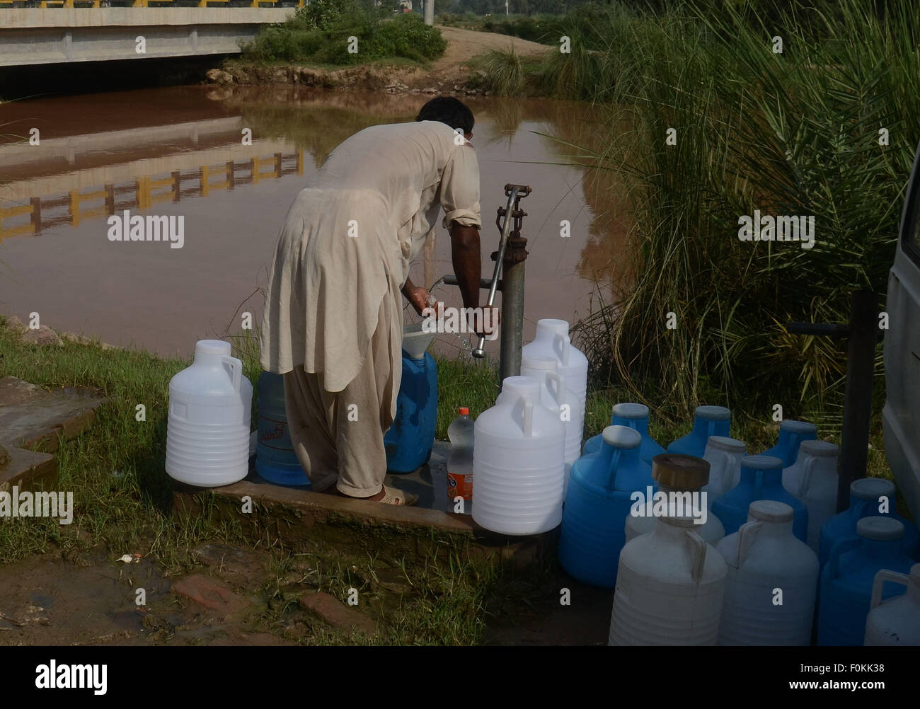 Pakistani water suppliers collecting water from the canal near Lahore ...