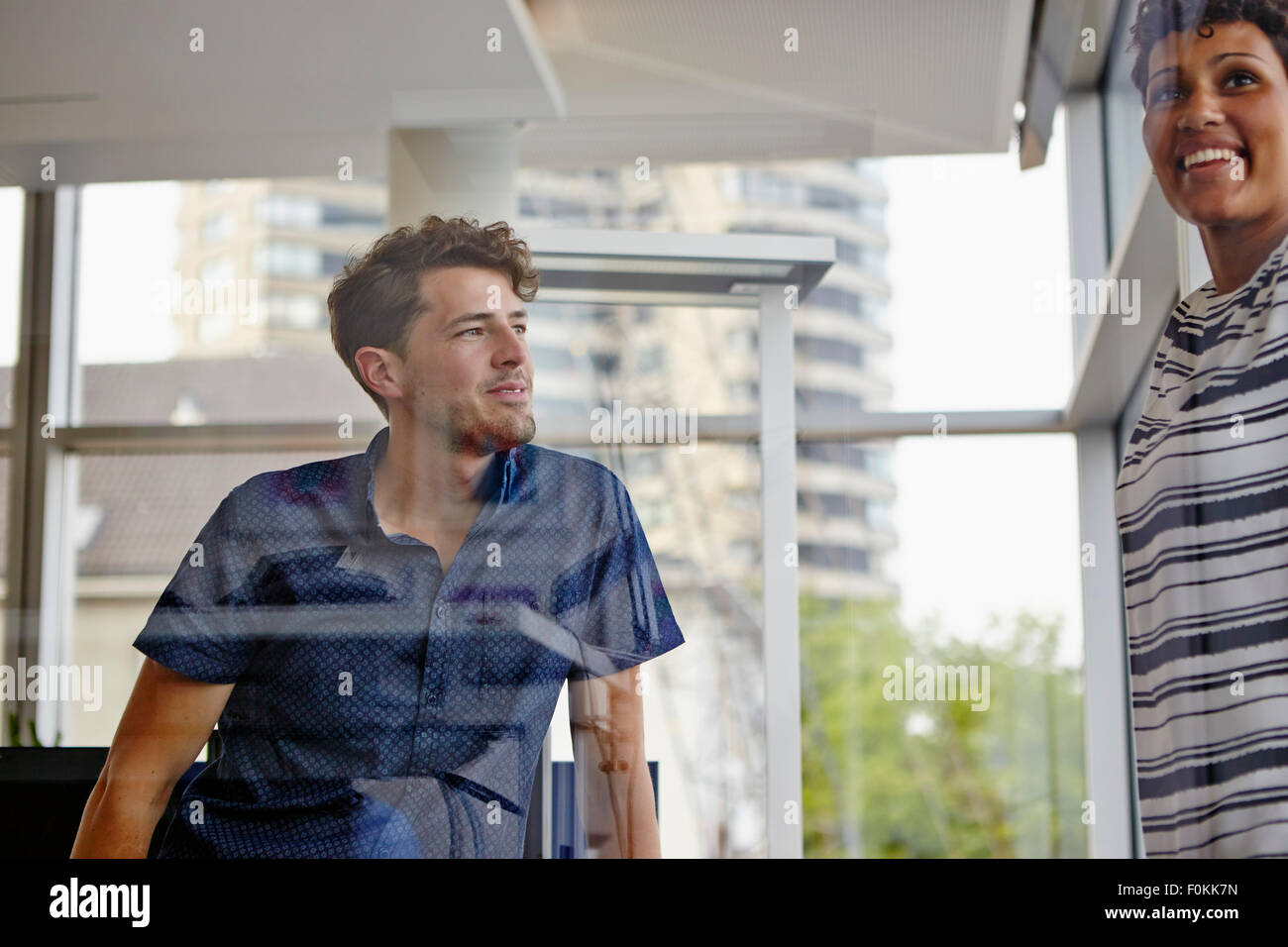 Two smiling colleagues in office Stock Photo - Alamy