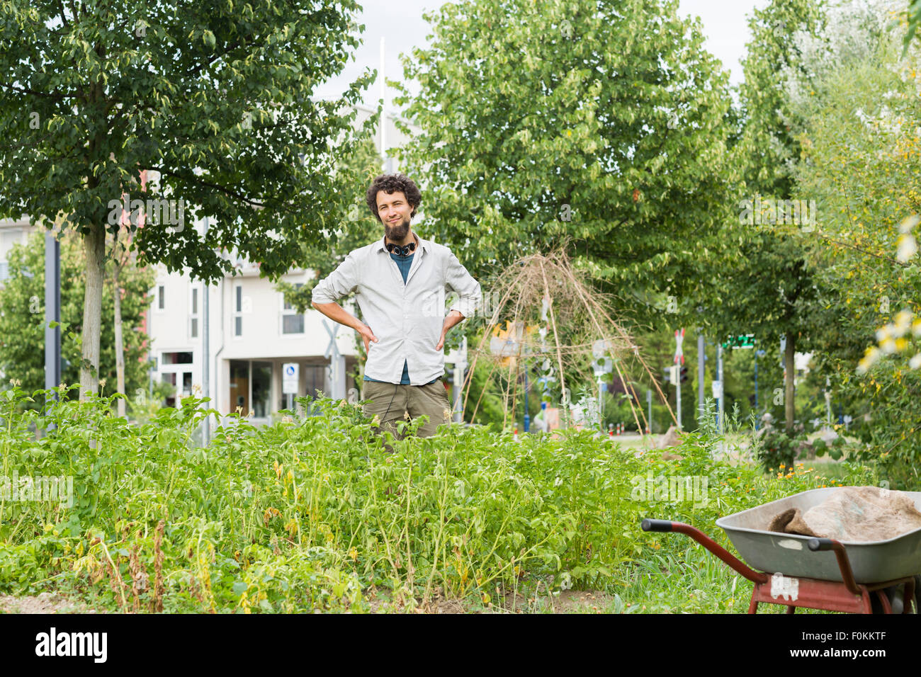 Young man standing in an urban garden Stock Photo - Alamy