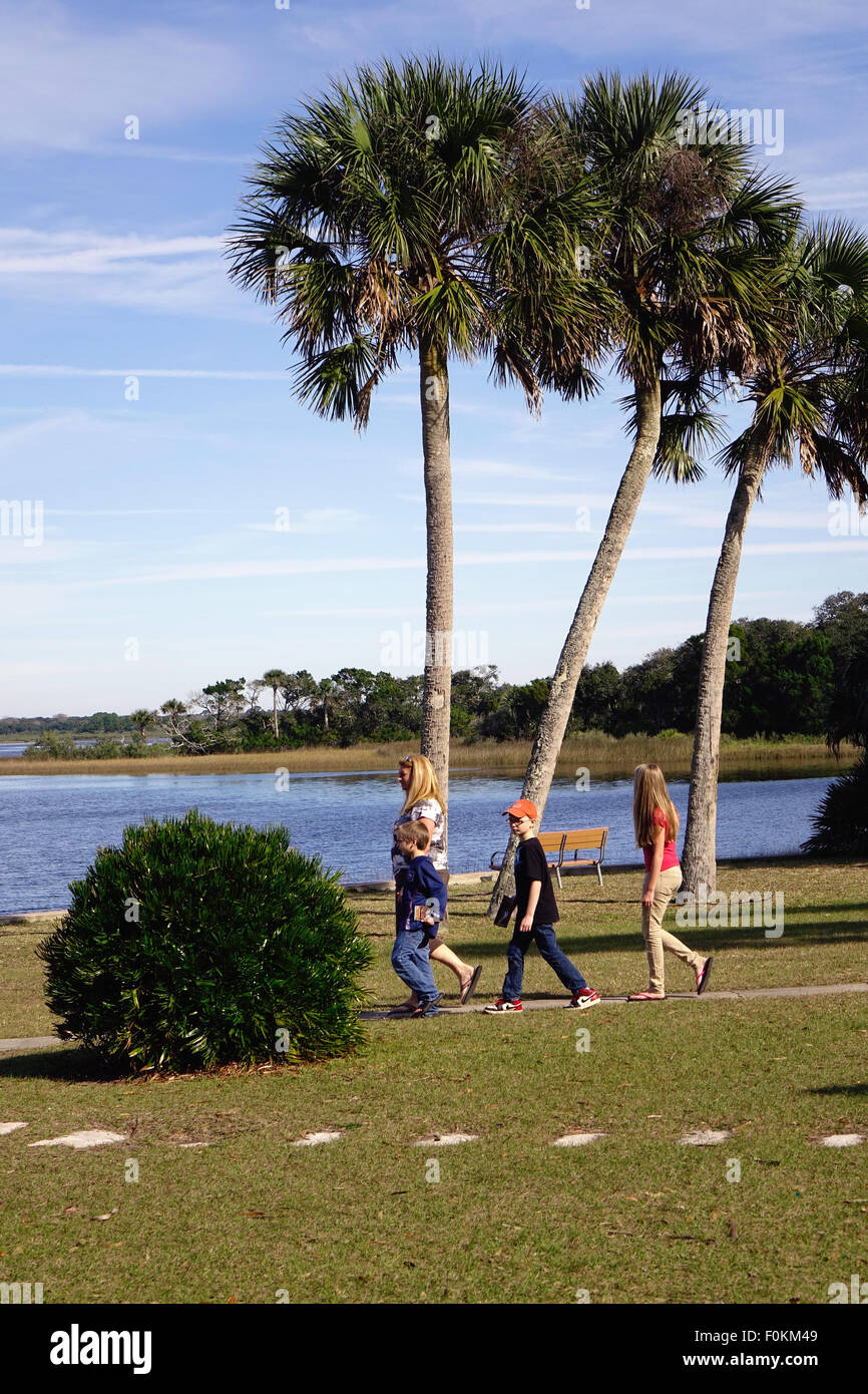 A family on the lawn near Pellicer Creek at Princess Place Preserve ...