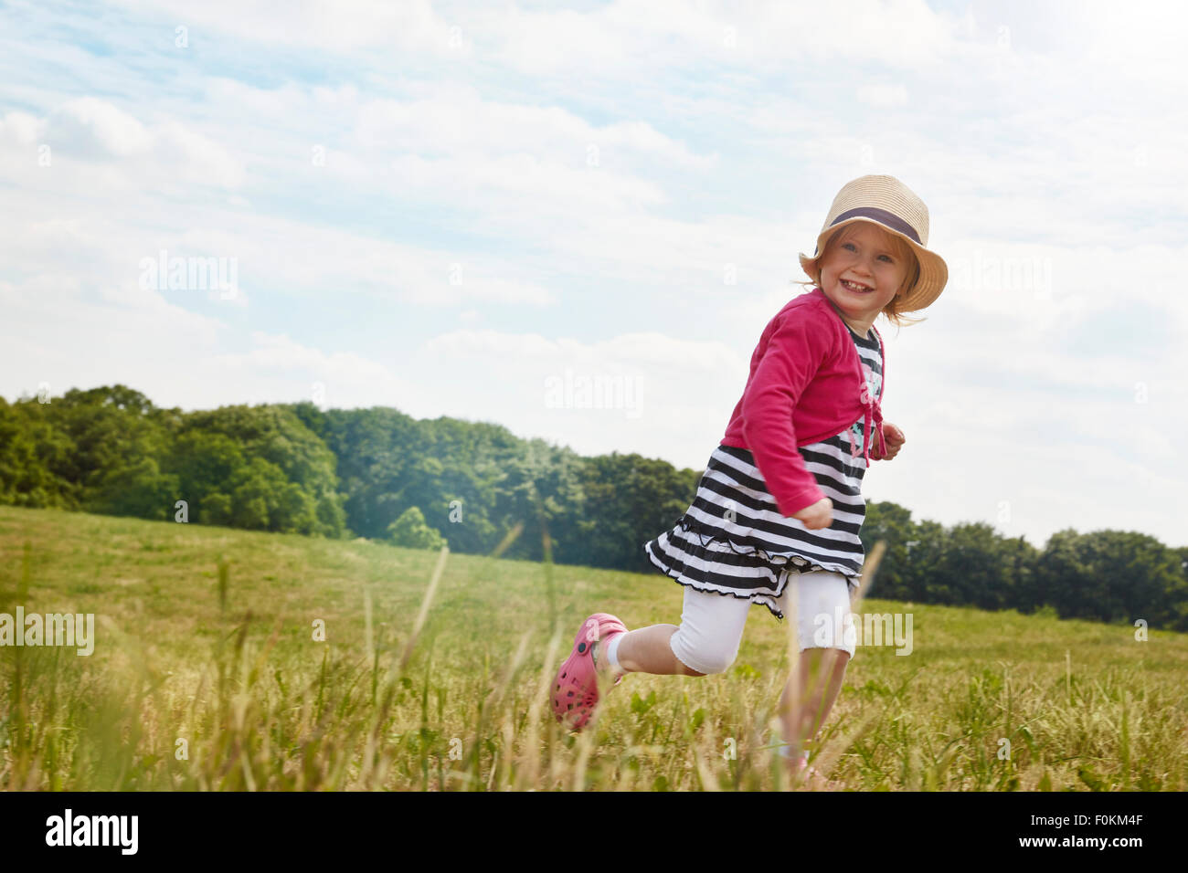 Little girl running on a meadow Stock Photo - Alamy