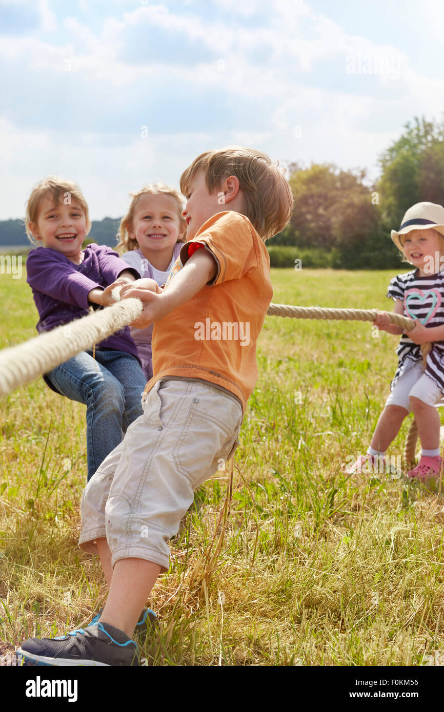 Children playing on a meadow Stock Photo - Alamy