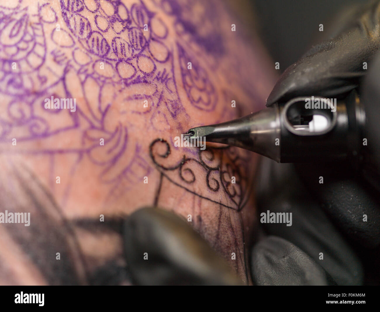 Close up tattoo artist purple hi-res stock photography and images - Alamy