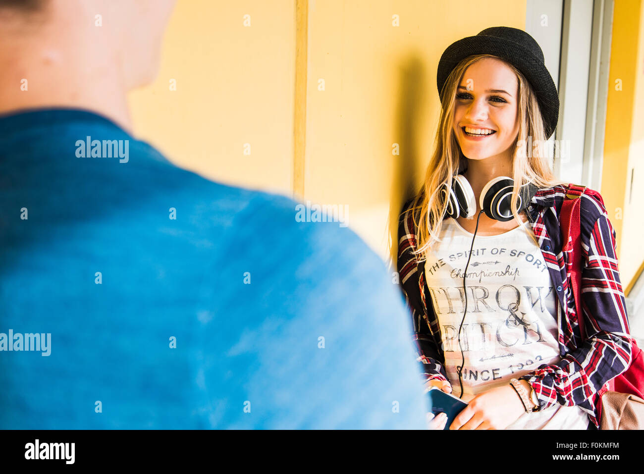 Teenage girl smiling at young man Stock Photo - Alamy