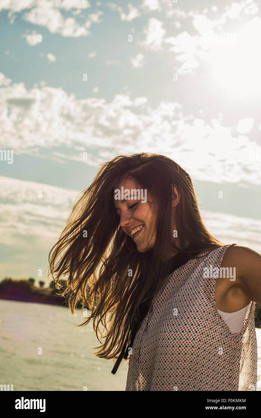 Happy young woman by the river Stock Photo - Alamy