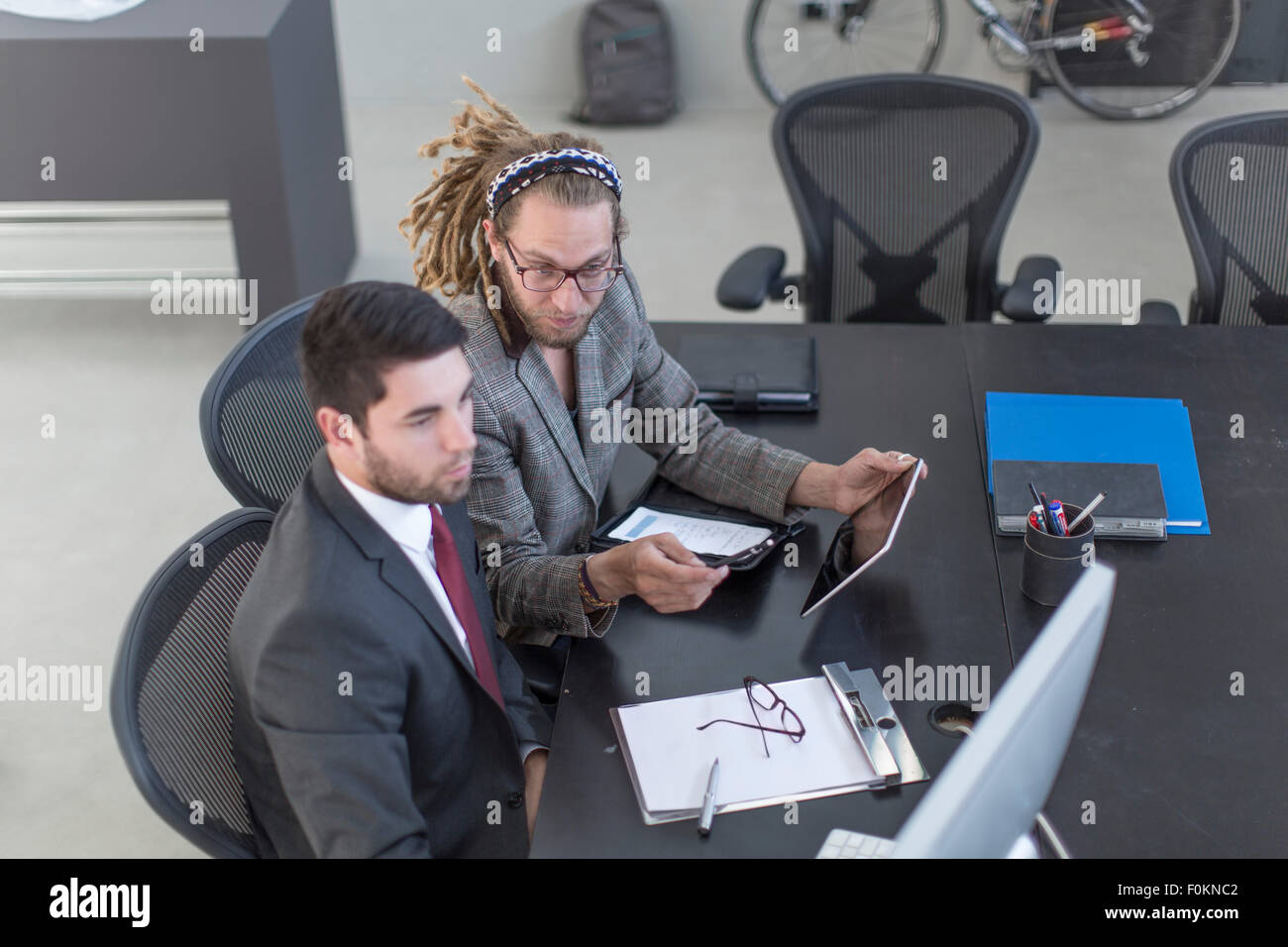 Businessmen working together in office Stock Photo - Alamy