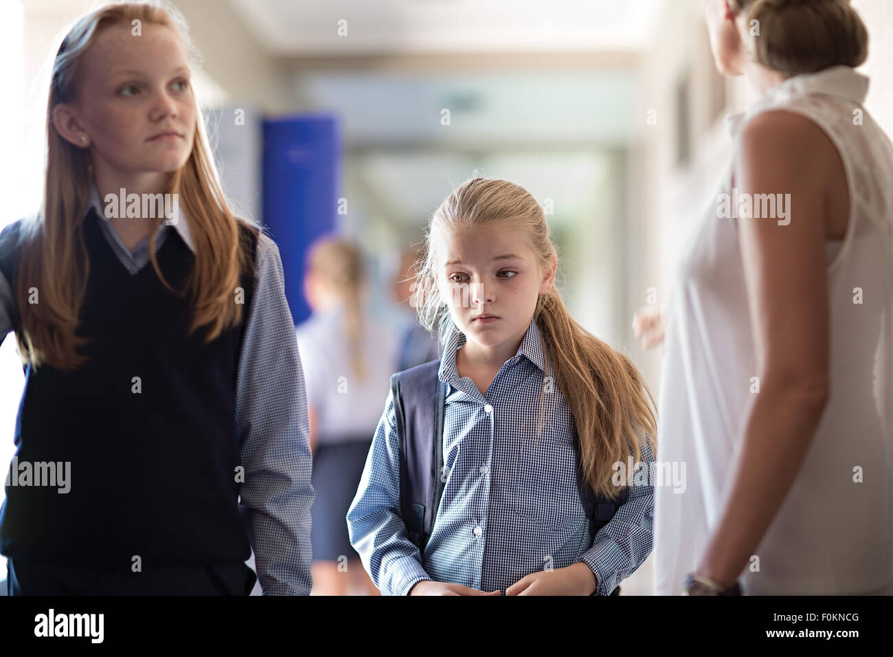Schoolgirls with teacher on hallway Stock Photo - Alamy