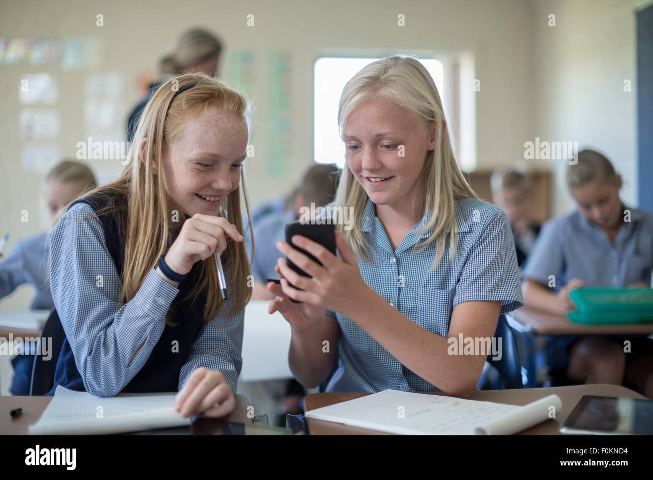 Two smiling schoolgirls in classroom hi-res stock photography and ...