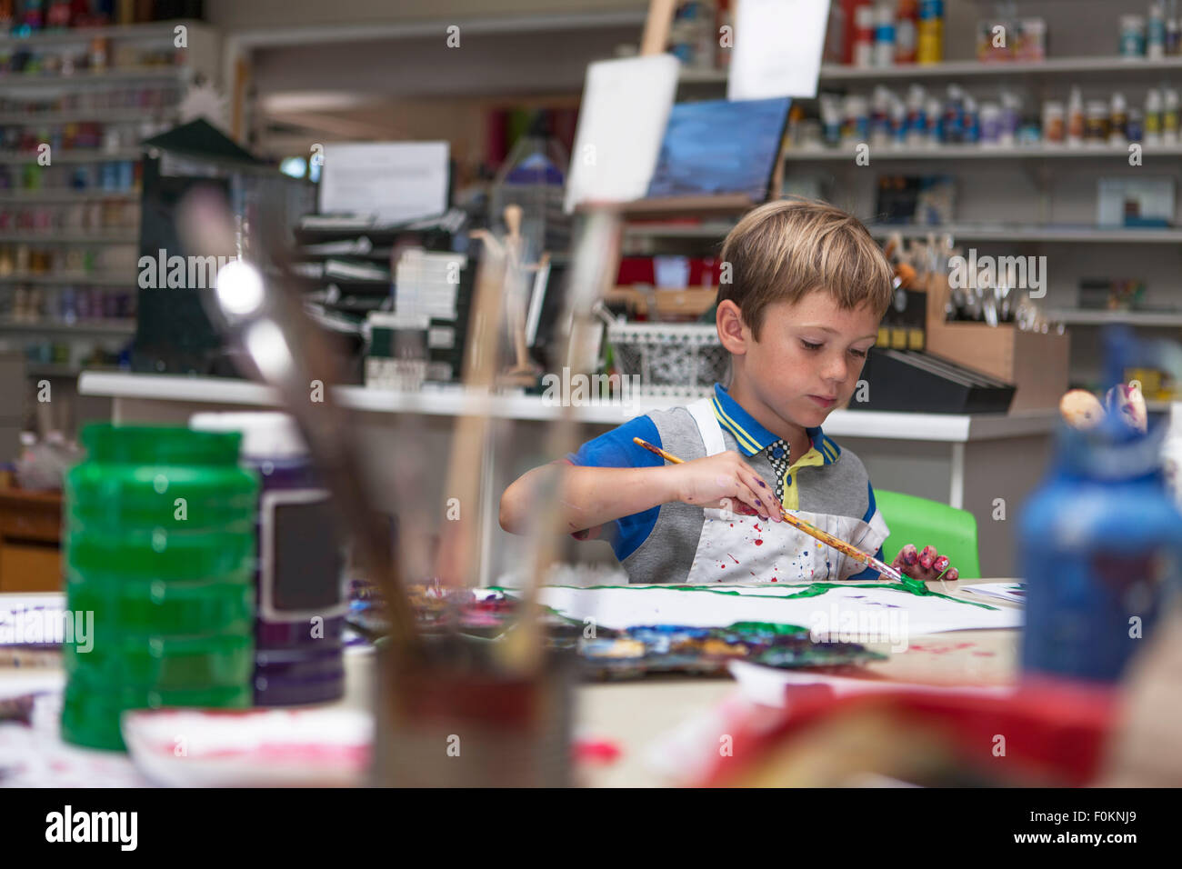 Little boy painting in an art class Stock Photo - Alamy