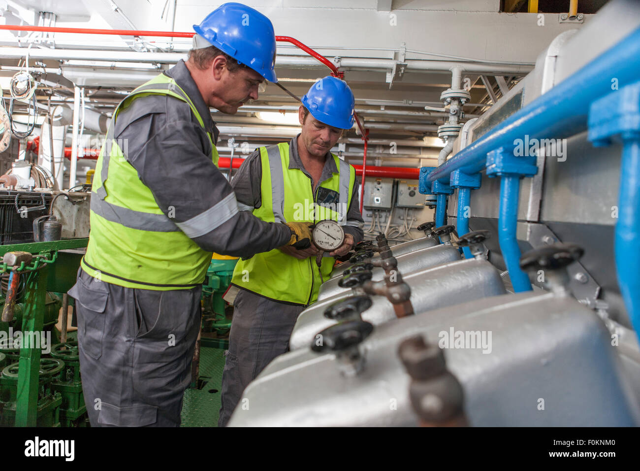 Crew working in engine room on a ship Stock Photo - Alamy