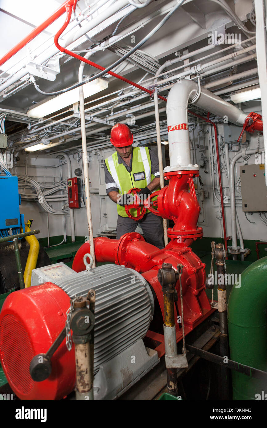 Man working in engine room on a ship Stock Photo - Alamy