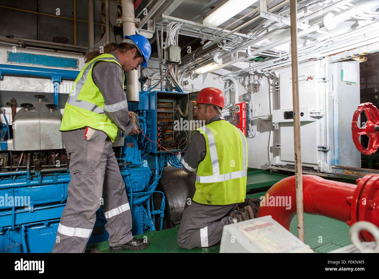 Crew working in engine room on a ship Stock Photo - Alamy