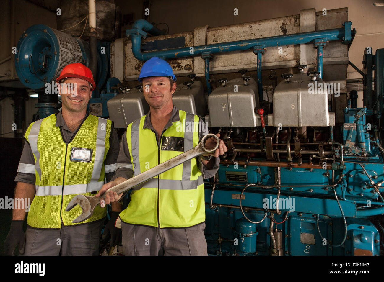 Portrait of two smiling mechanics in engine room on a ship Stock Photo ...