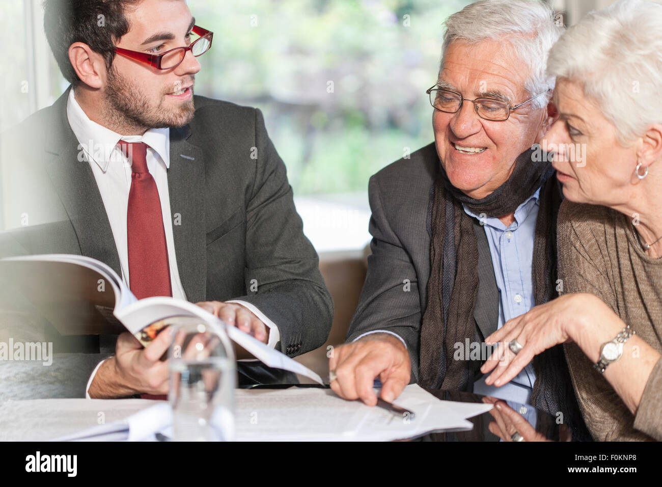 Senior couple at home having a meeting with salesman Stock Photo - Alamy