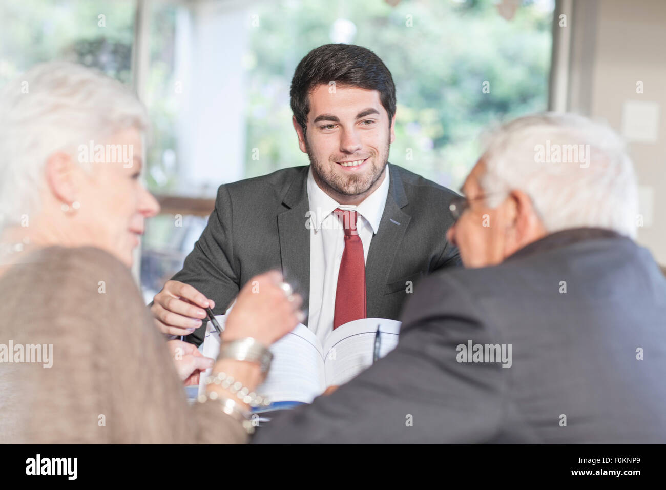Senior couple at home having a meeting with salesman Stock Photo - Alamy