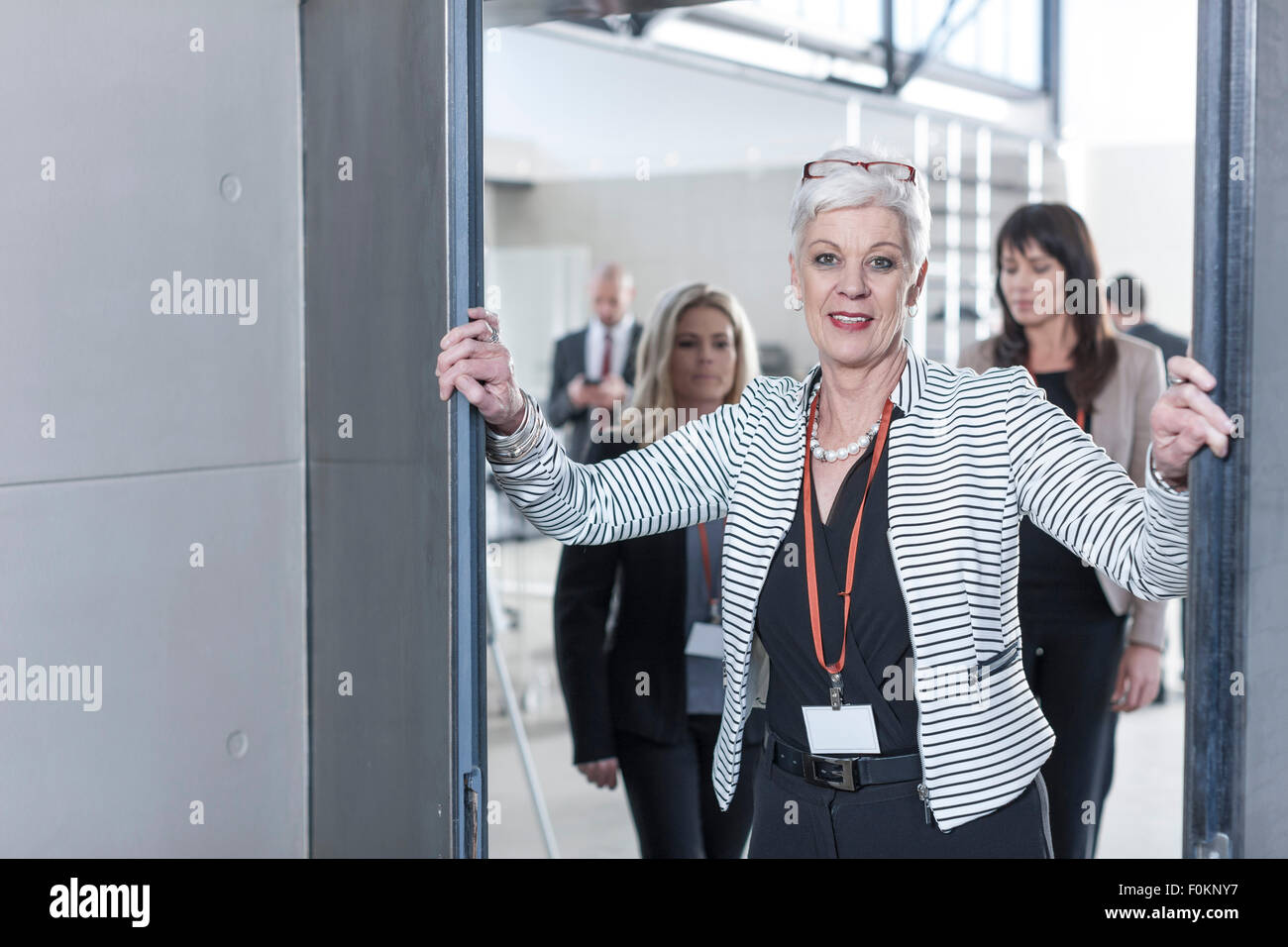 Group of business people entering office Stock Photo - Alamy